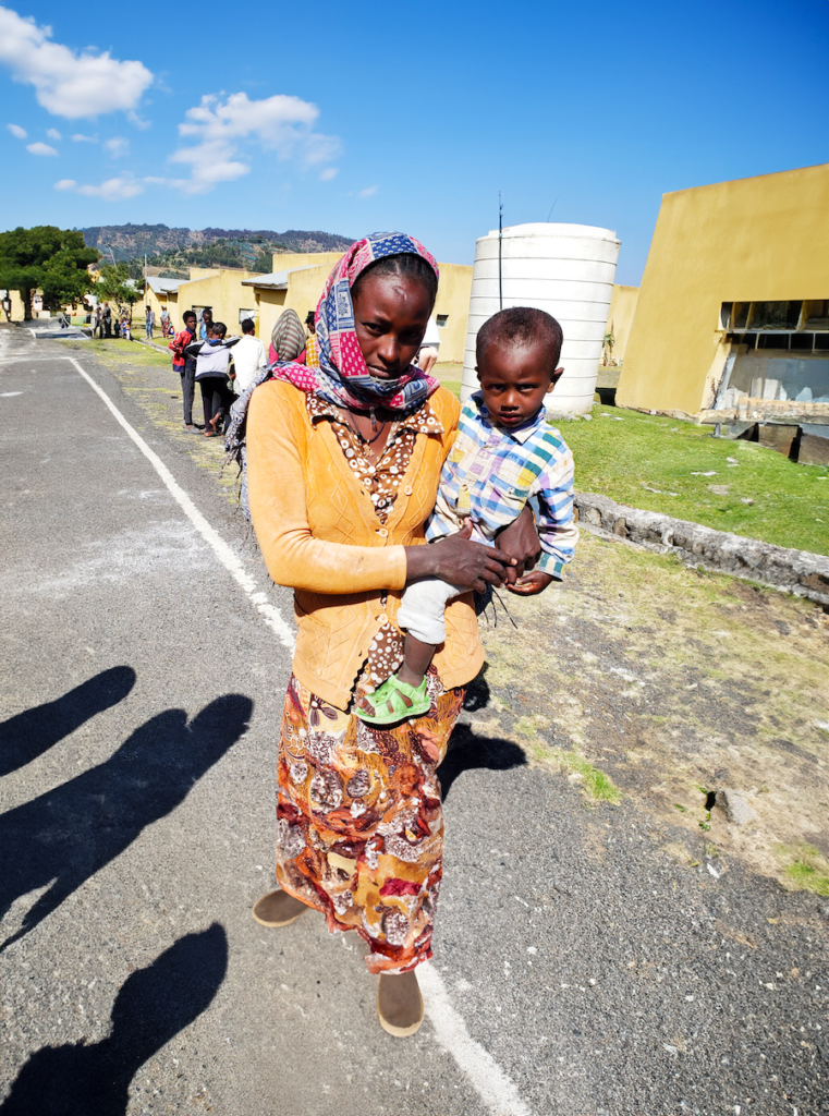 Clinging to her baby boy, she fled for her life